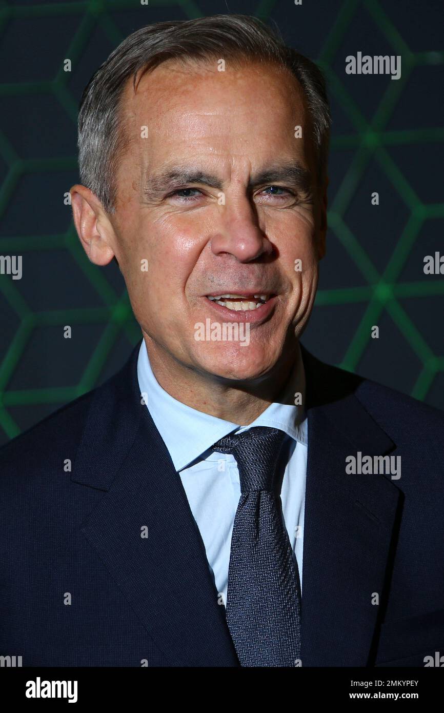 Mark Carney poses for photographers upon arrival at the Bloomberg and ...