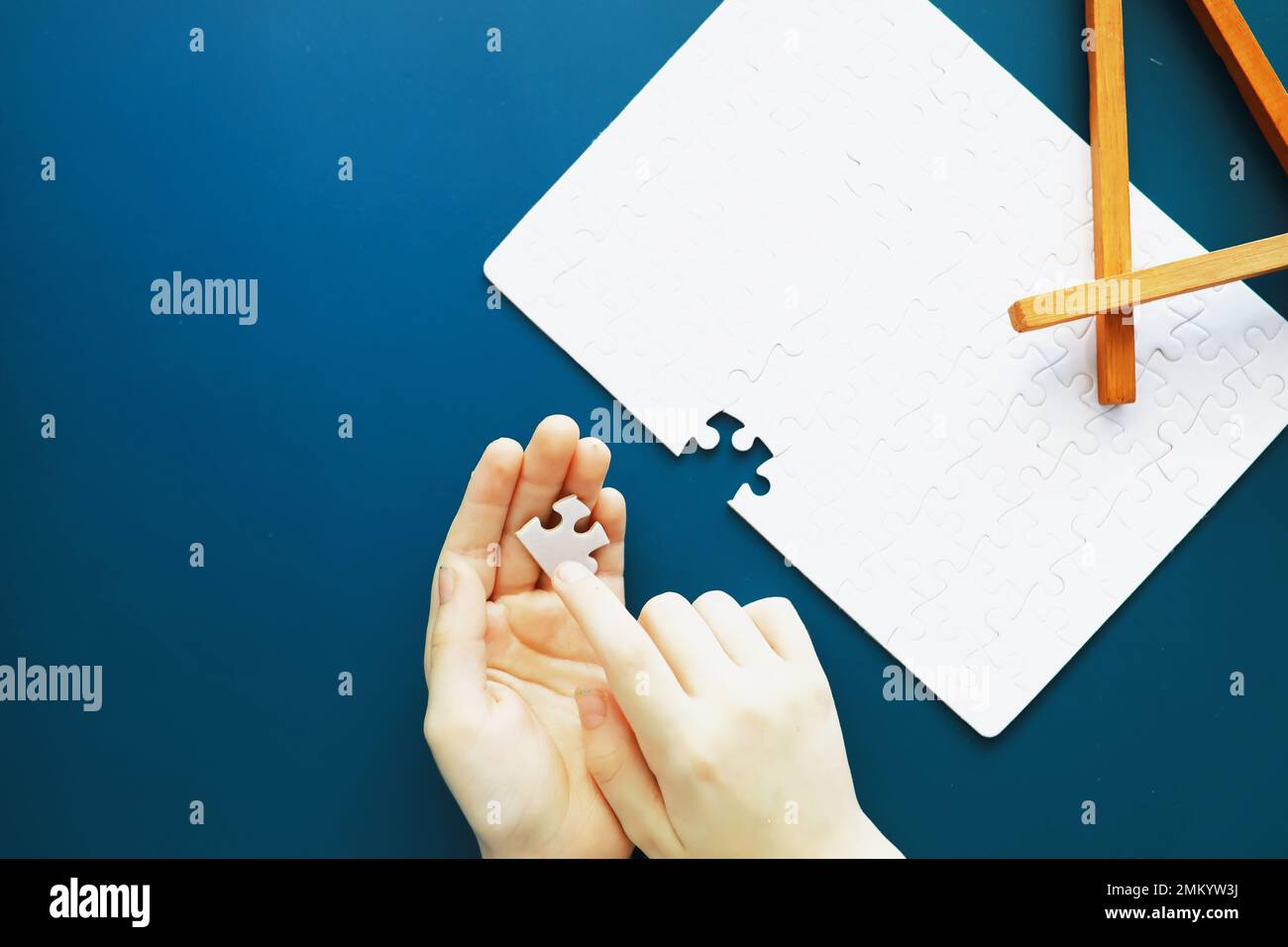 Intellectual puzzles. The puzzle empty. The hand puts together puzzle ...