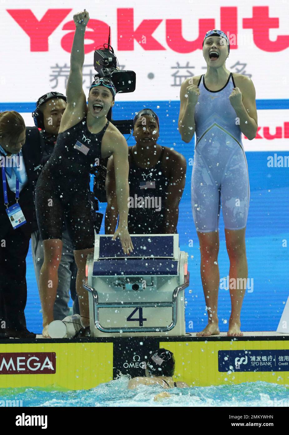 USA's Mallory Comerford, left and Olivia Smoliga react after winning ...