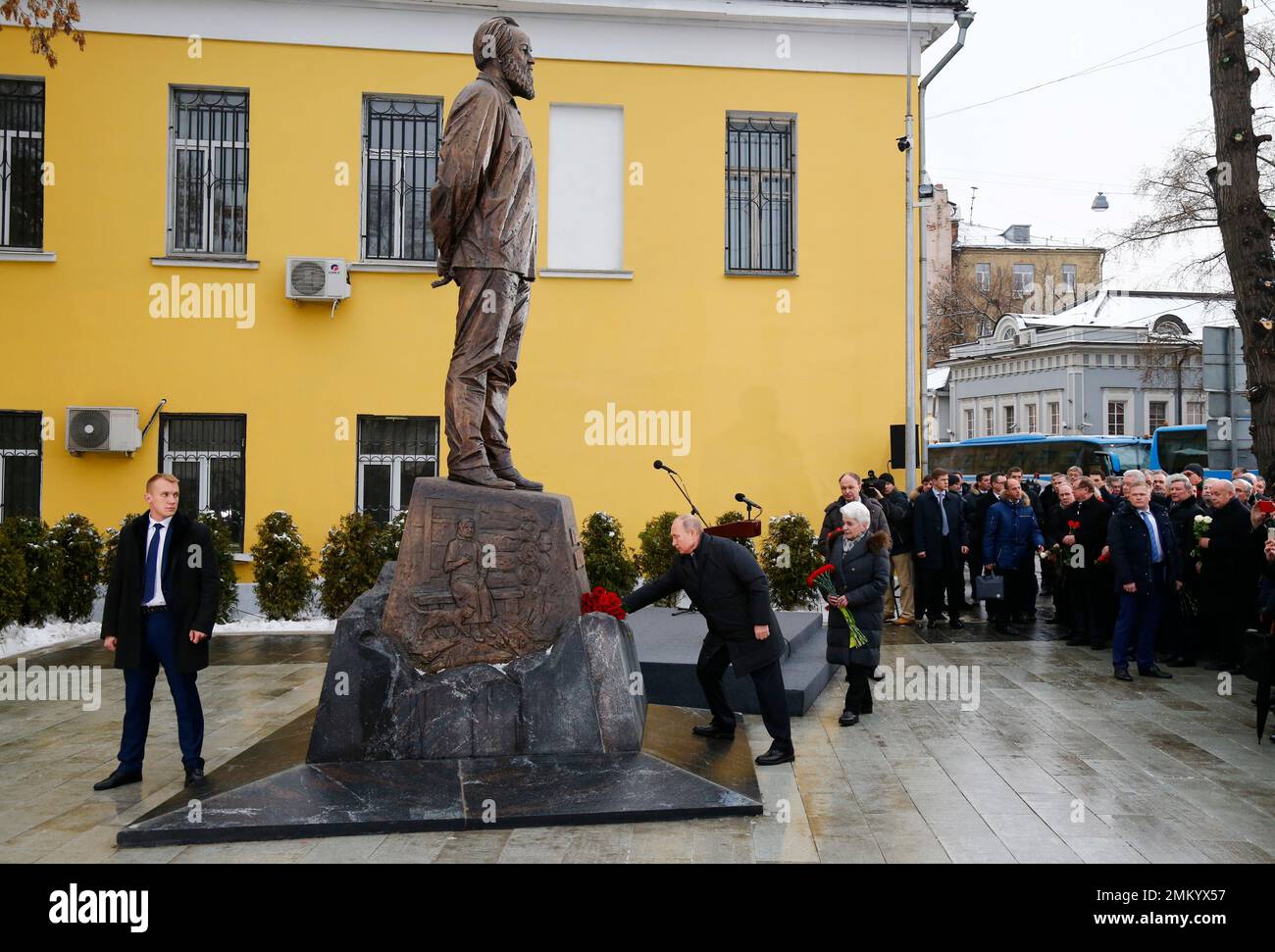 Russian President Vladimir Putin puts flowers during the unveiling of a ...