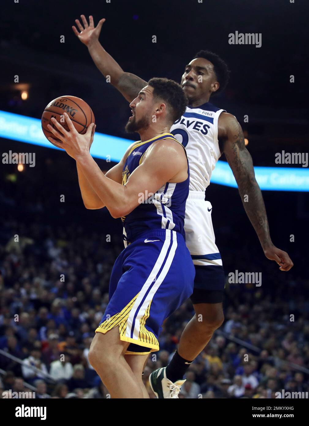 Golden State Warriors' Klay Thompson, left, shoots against Minnesota ...