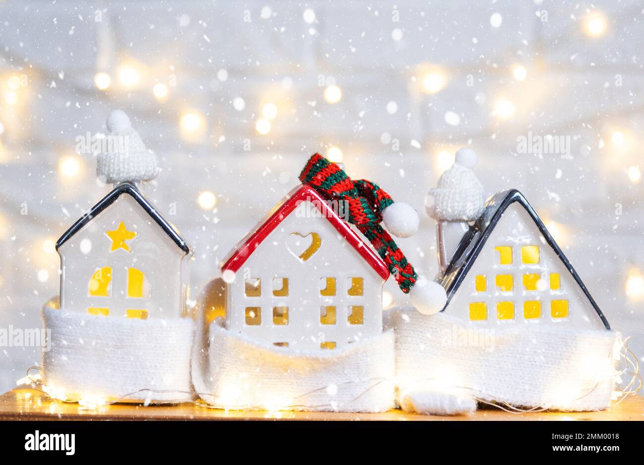 Cozy house is wrapped in a hat and scarf in a snowstorm -window sill ...