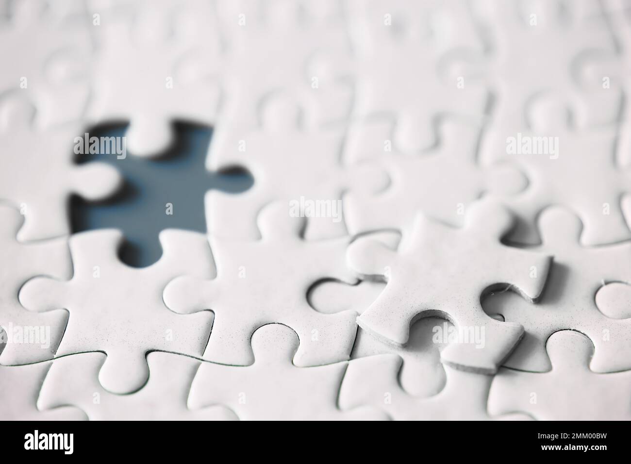 Clean puzzle elements on the background. Empty puzzle piece on table ...
