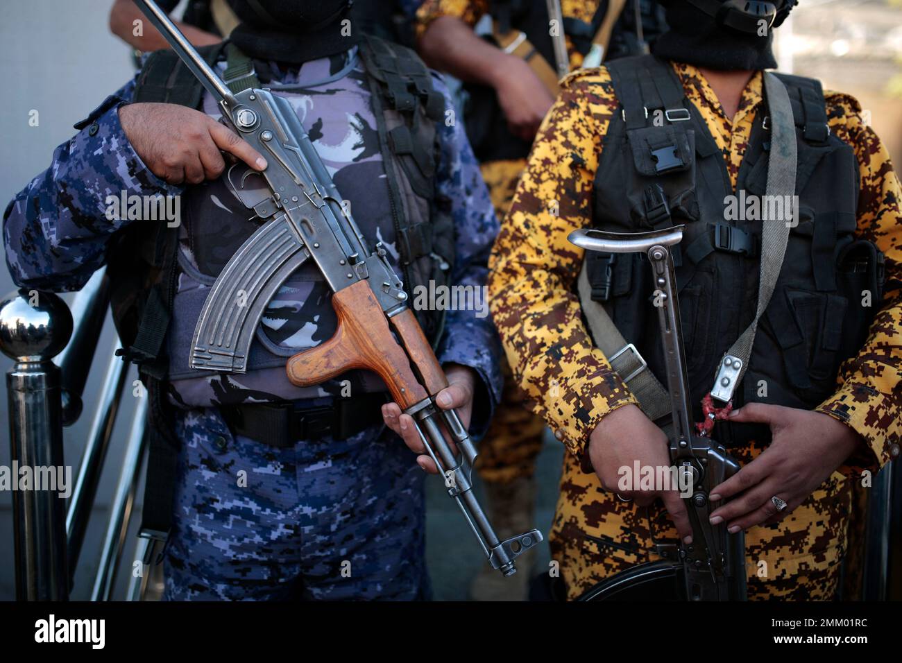 Yemeni police troopers stand guard at a door of the U.N. offices during ...