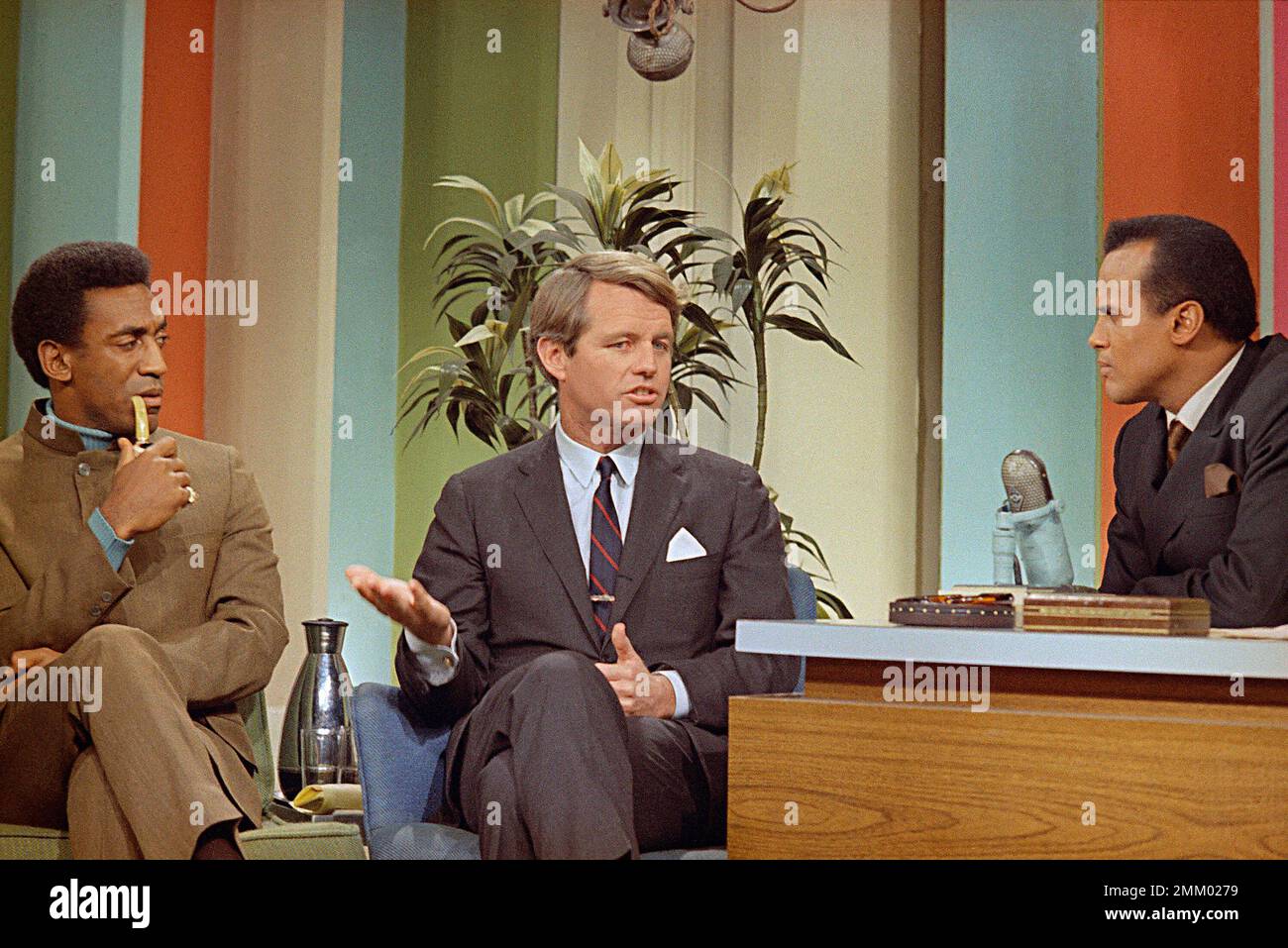 Seated at center flanked by comedian Bill Cosby, left, and guest host ...