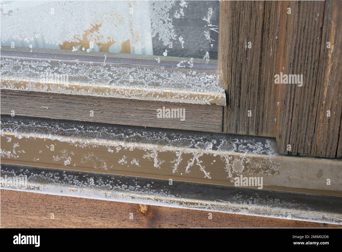 Close up of corner of wooden window frame on cold winter day with ...