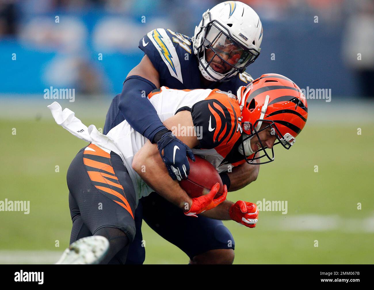Los Angeles Chargers defensive back Adrian Phillips, top, tackles ...