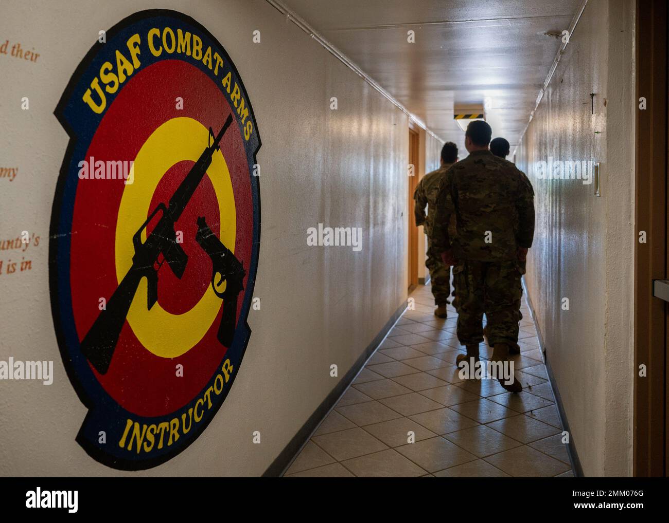 U.S. Air Force Airmen from various career fields walk down the halls of ...