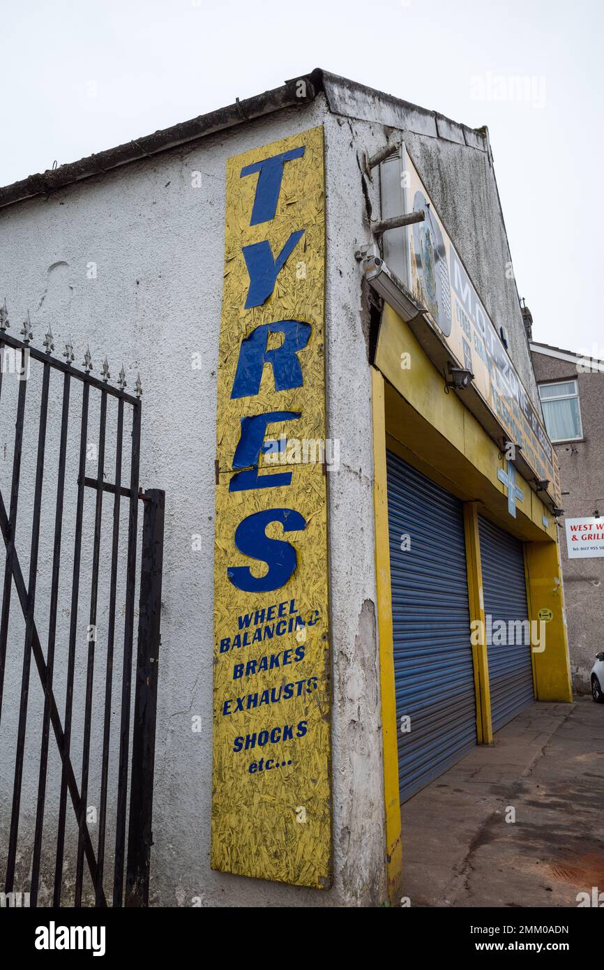 Yellow and blue tyres wooden sign Stock Photo - Alamy