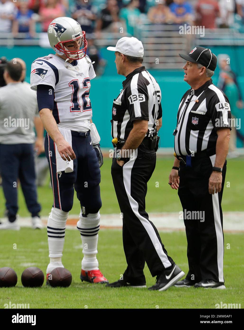 New England Patriots quarterback Tom Brady (12) talks to referee Pete ...