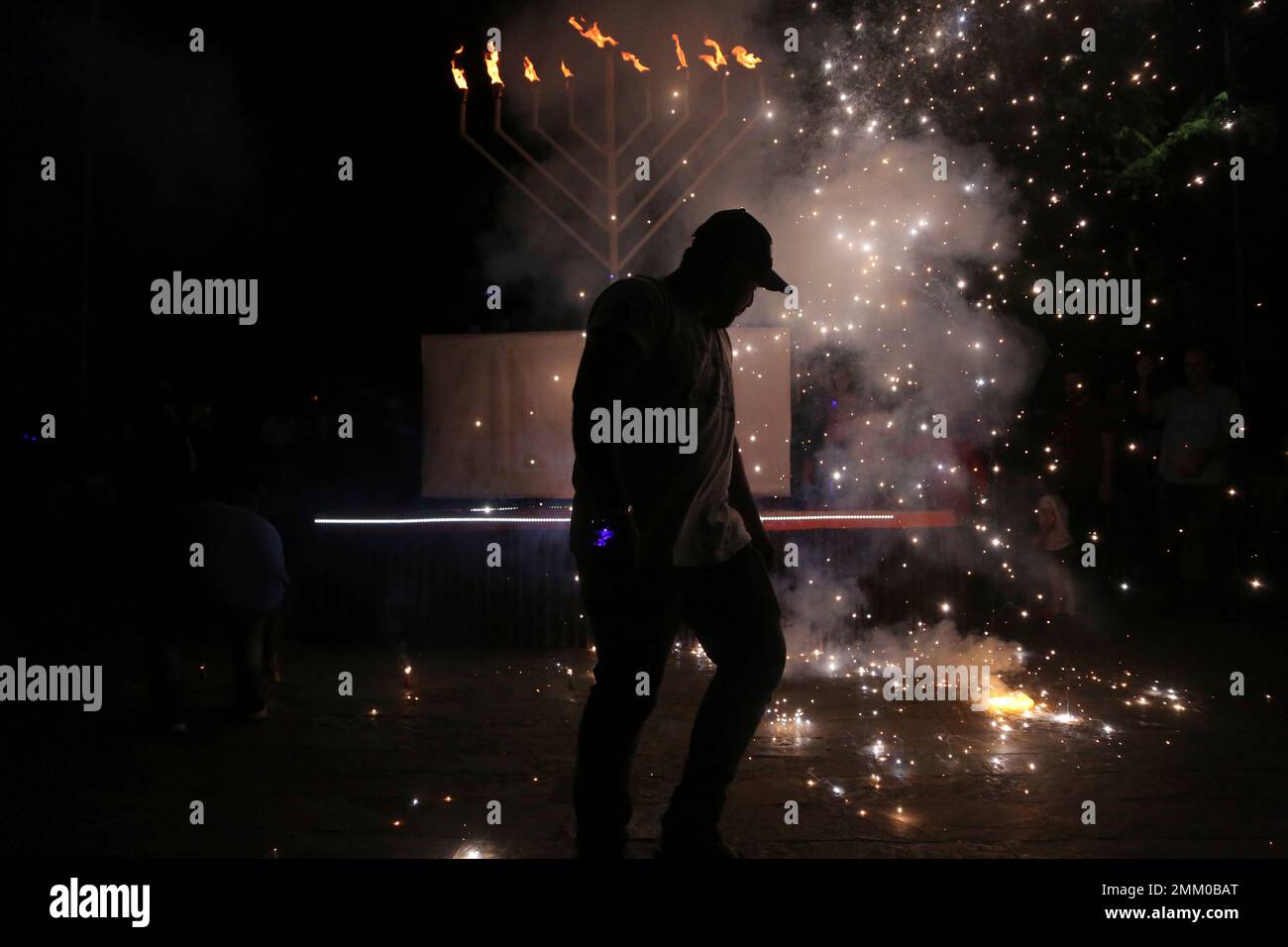 A member of Jewish community lights fire crackers at the landmark ...