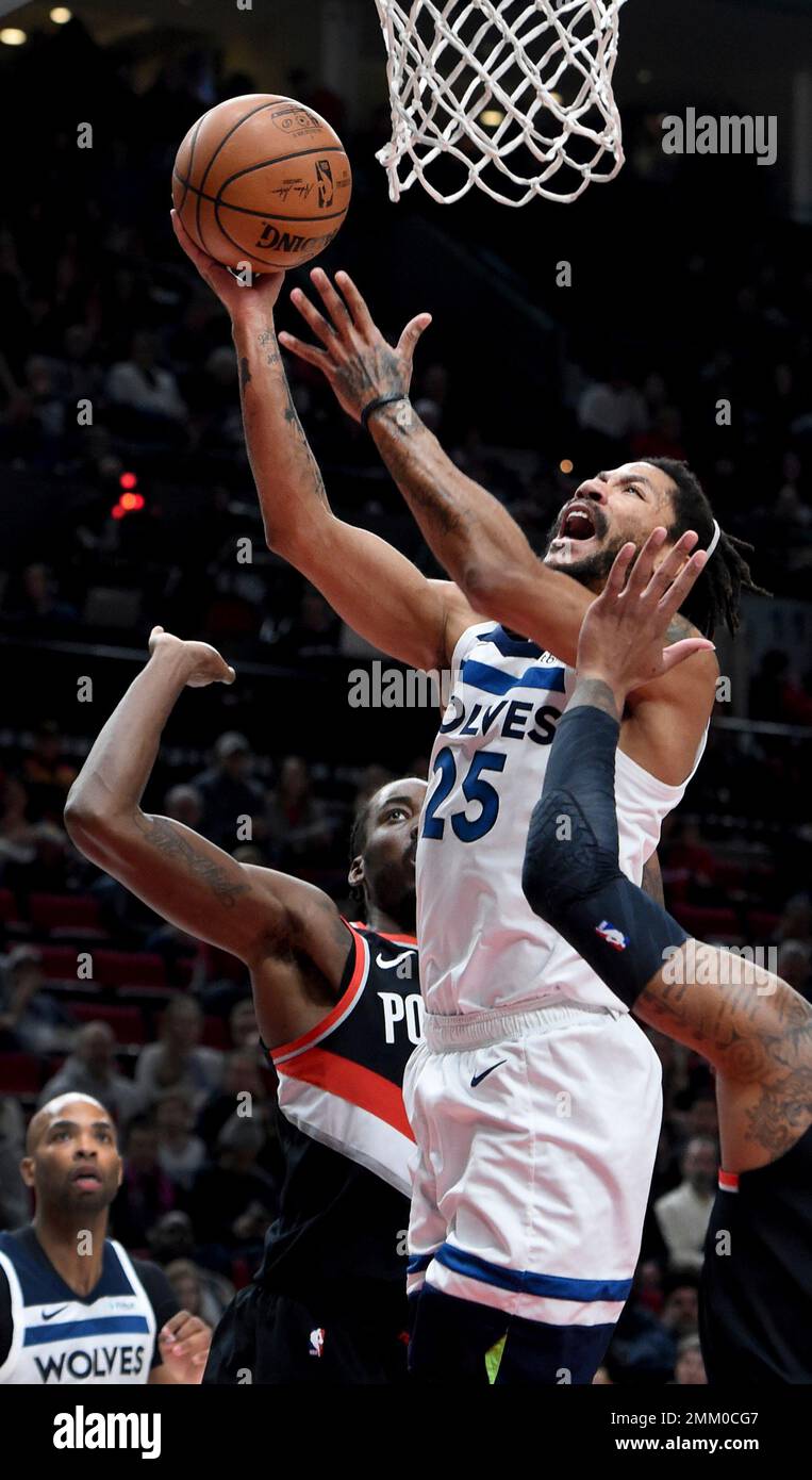 Minnesota Timberwolves guard Derrick Rose, right, drives to the basket ...