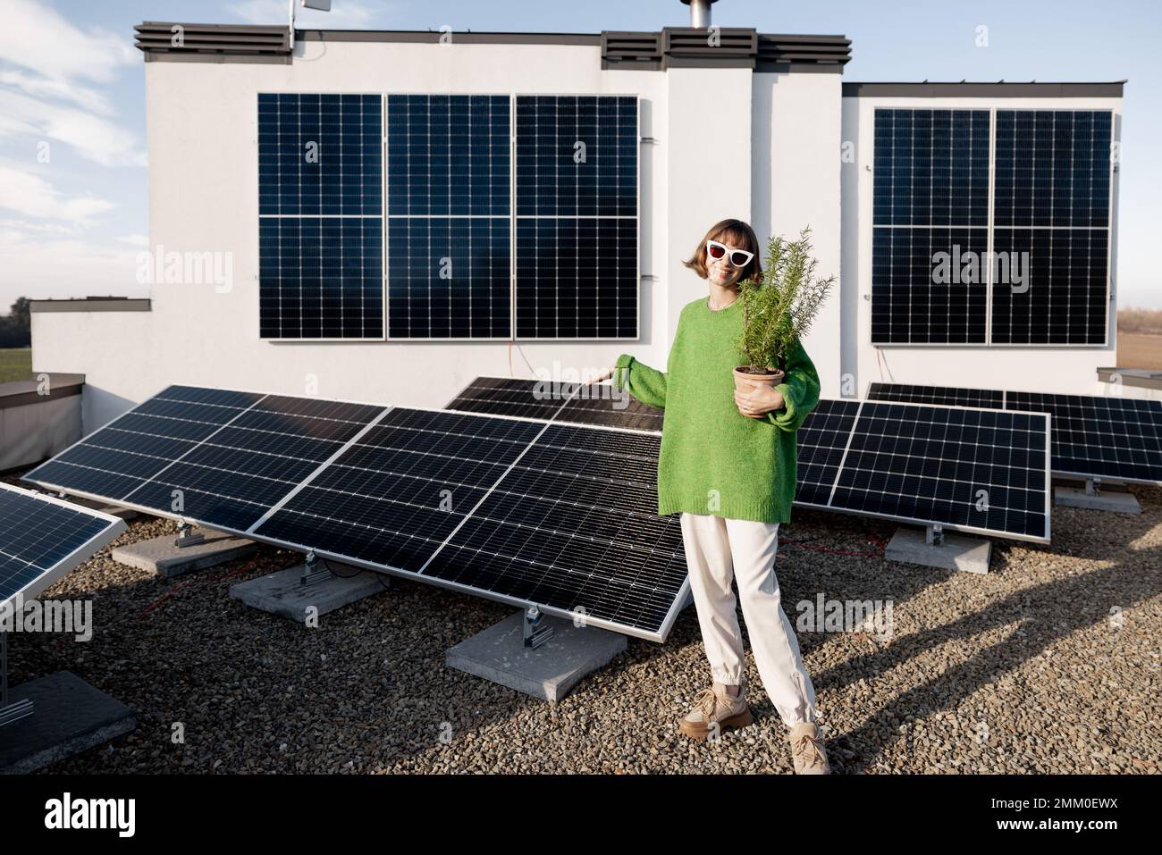 Happy house owner with a solar plant Stock Photo - Alamy