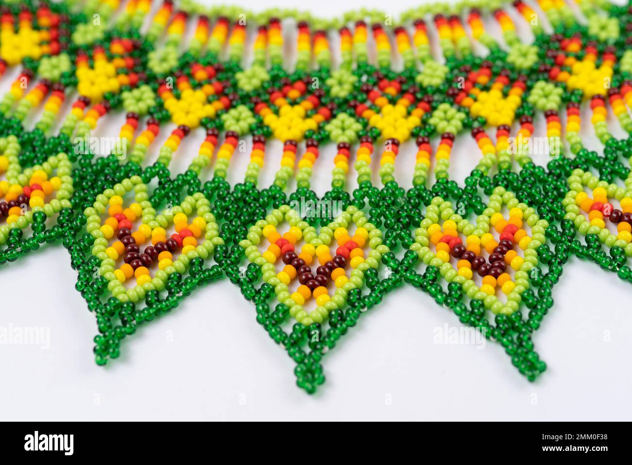 handmade colorful bead necklace close-up isolated on white background ...