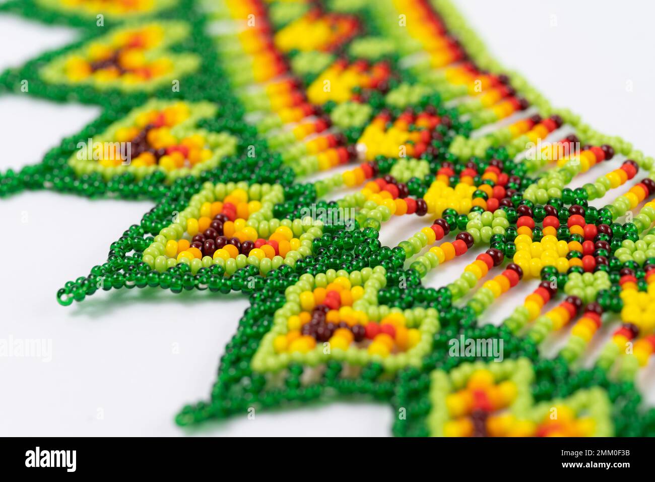 handmade colorful bead necklace close-up isolated on white background ...