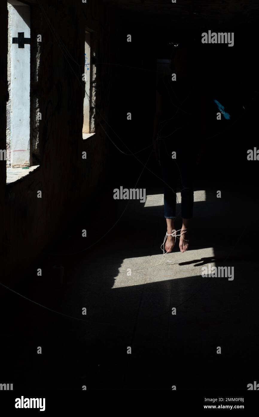 Fear concept an identified person trapped in a dark abandoned room ...