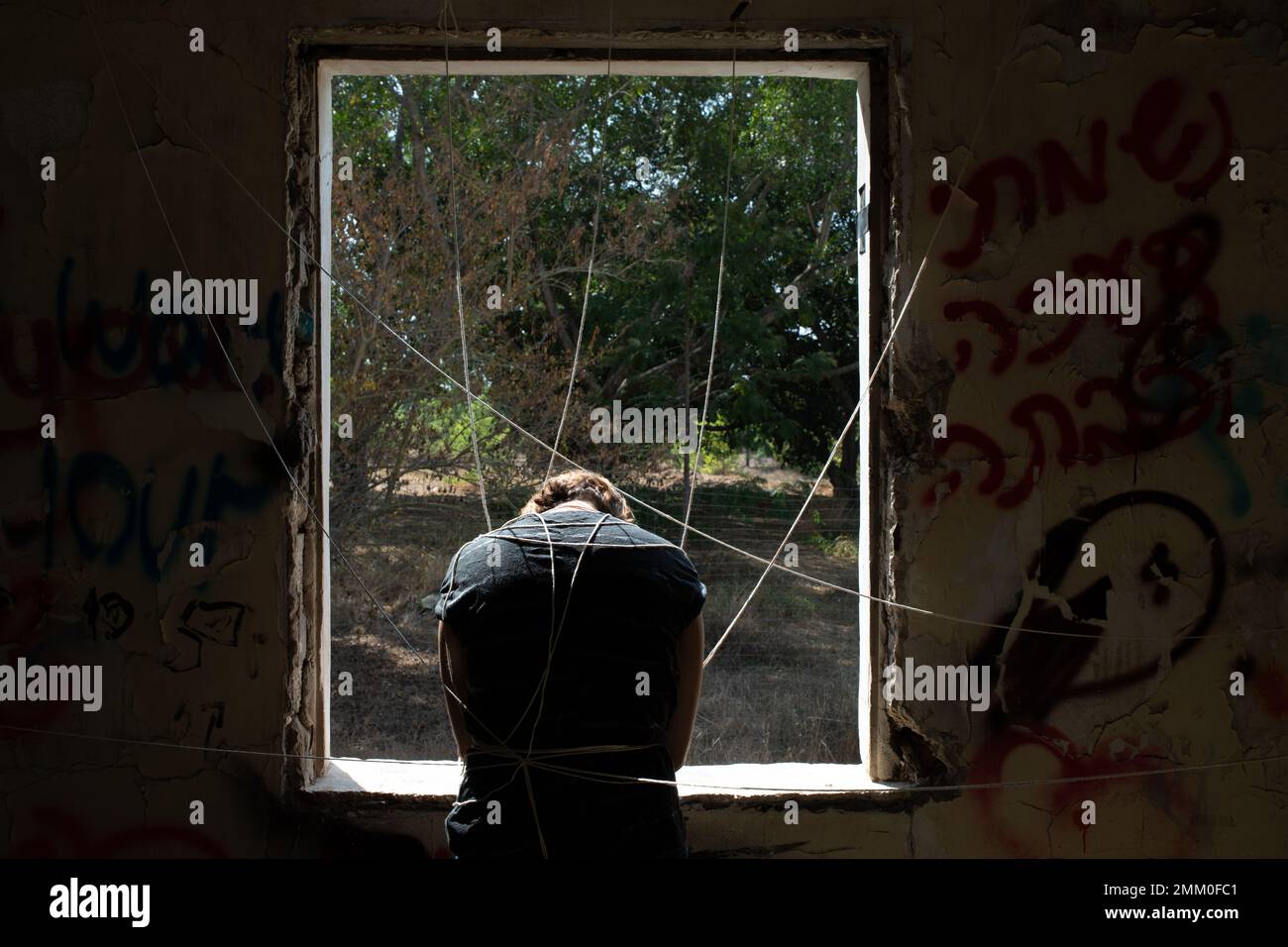 Fear concept an identified person trapped in a dark abandoned room ...