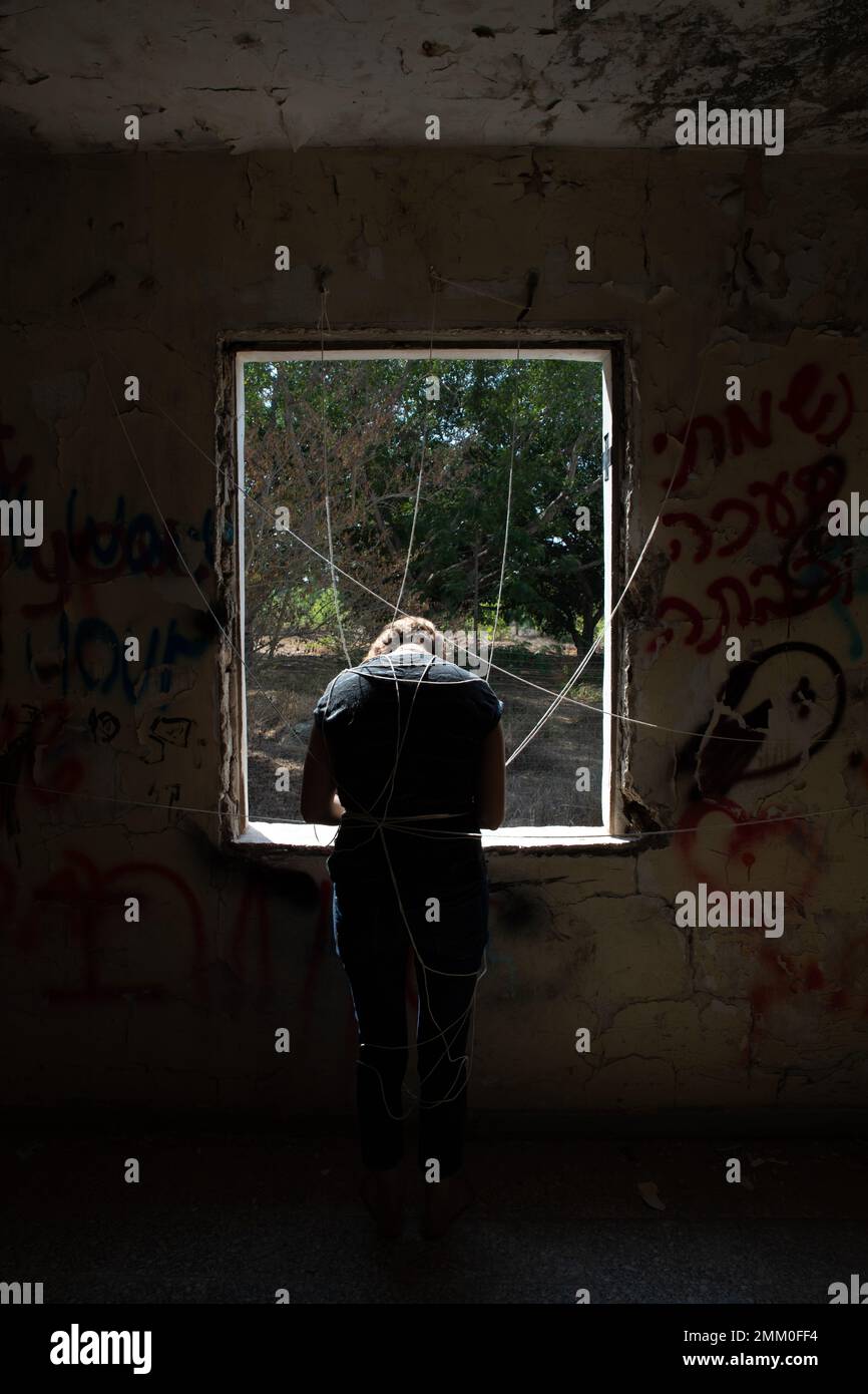 Fear concept an identified person trapped in a dark abandoned room ...