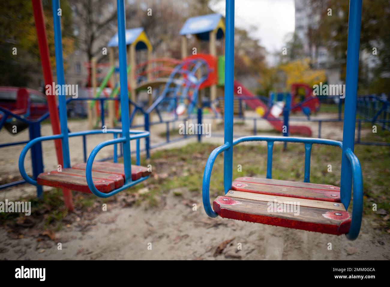 a lonely empty swing on a playground without people Stock Photo - Alamy