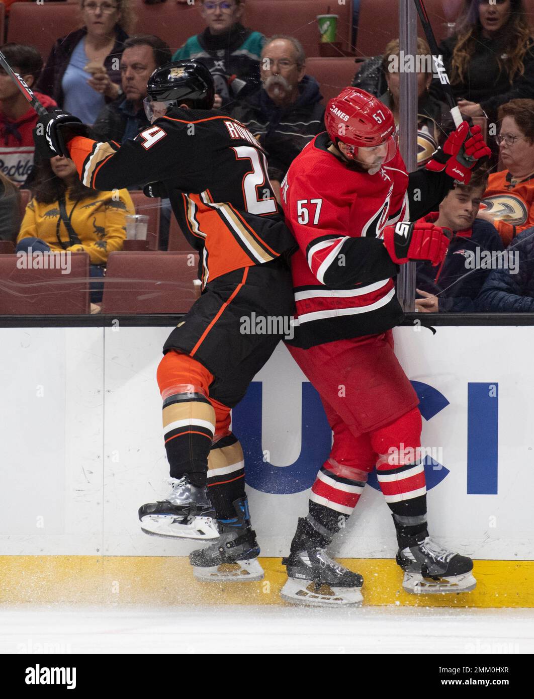 Anaheim Ducks right wing Carter Rowney, left, body-checks Carolina ...