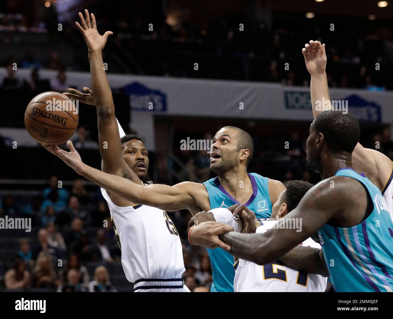 Charlotte Hornets' Tony Parker, center, drives past Denver Nuggets ...