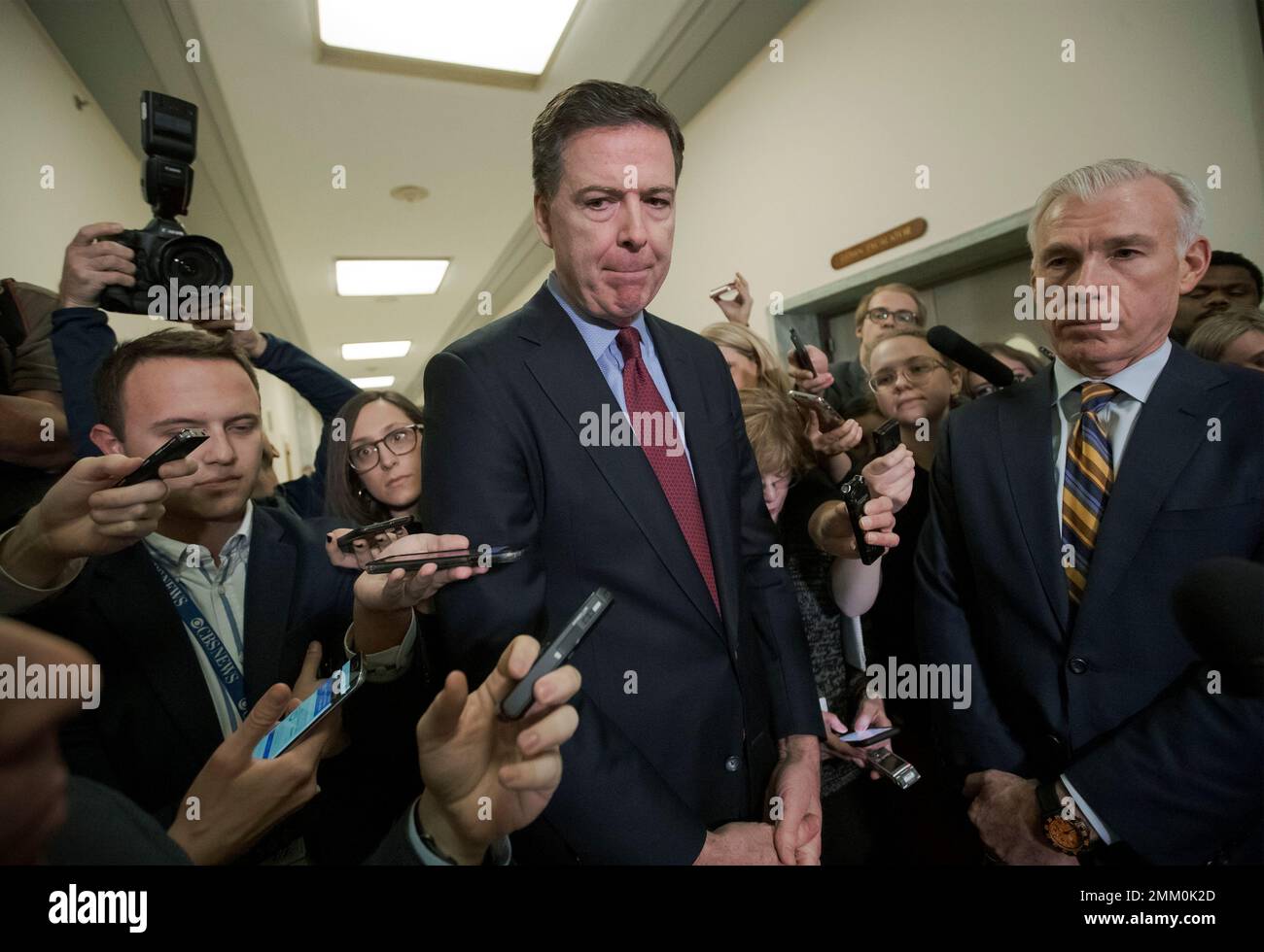 Former FBI Director James Comey, with his attorney, David Kelley, right ...