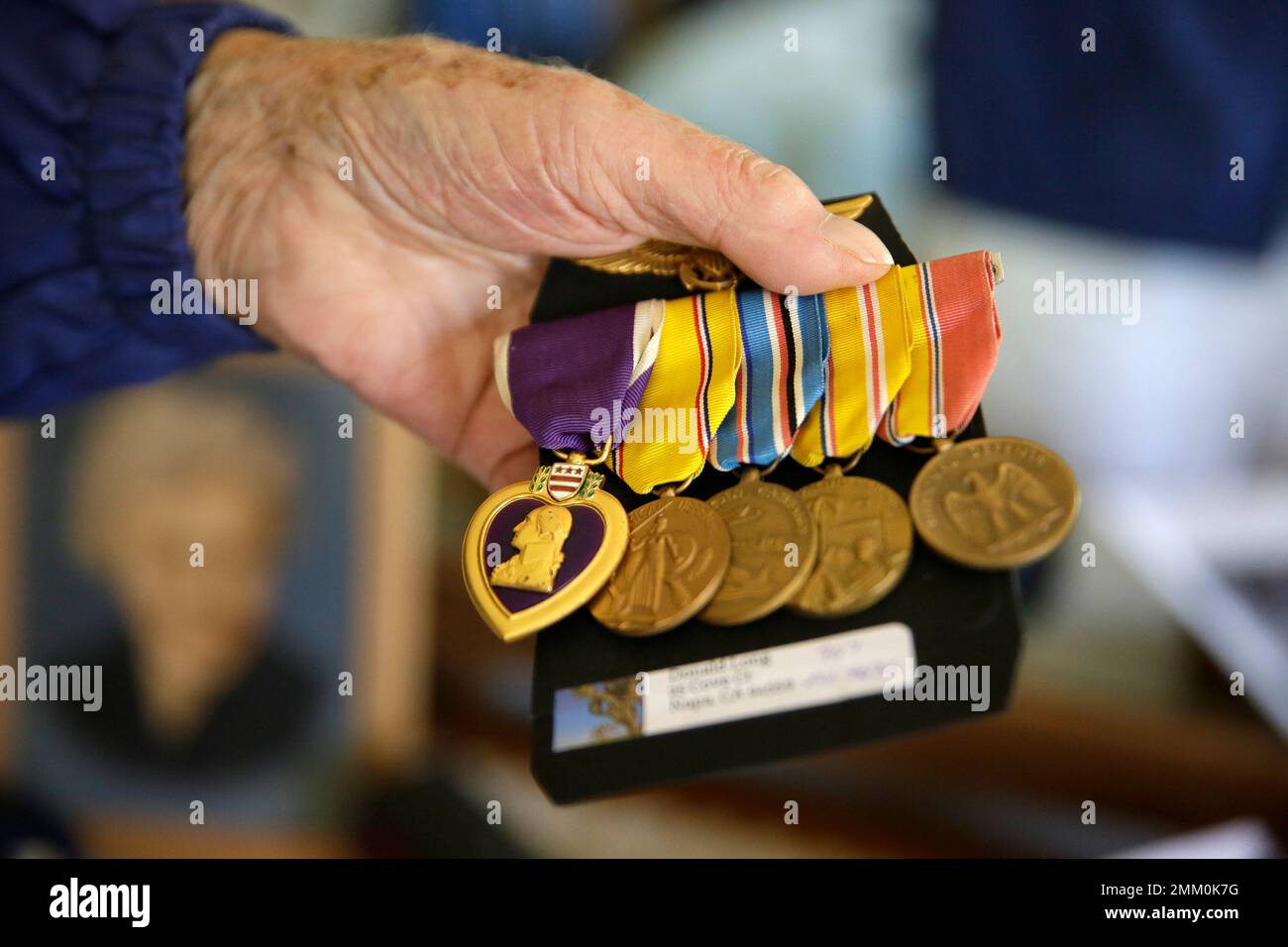 Don Long pulls out his Purple Heart and other medals at his home Friday ...