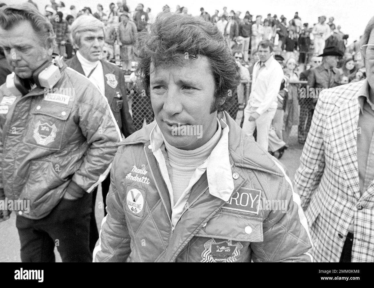 A discouraged Mario Andretti answer's a pit man's question as he ...