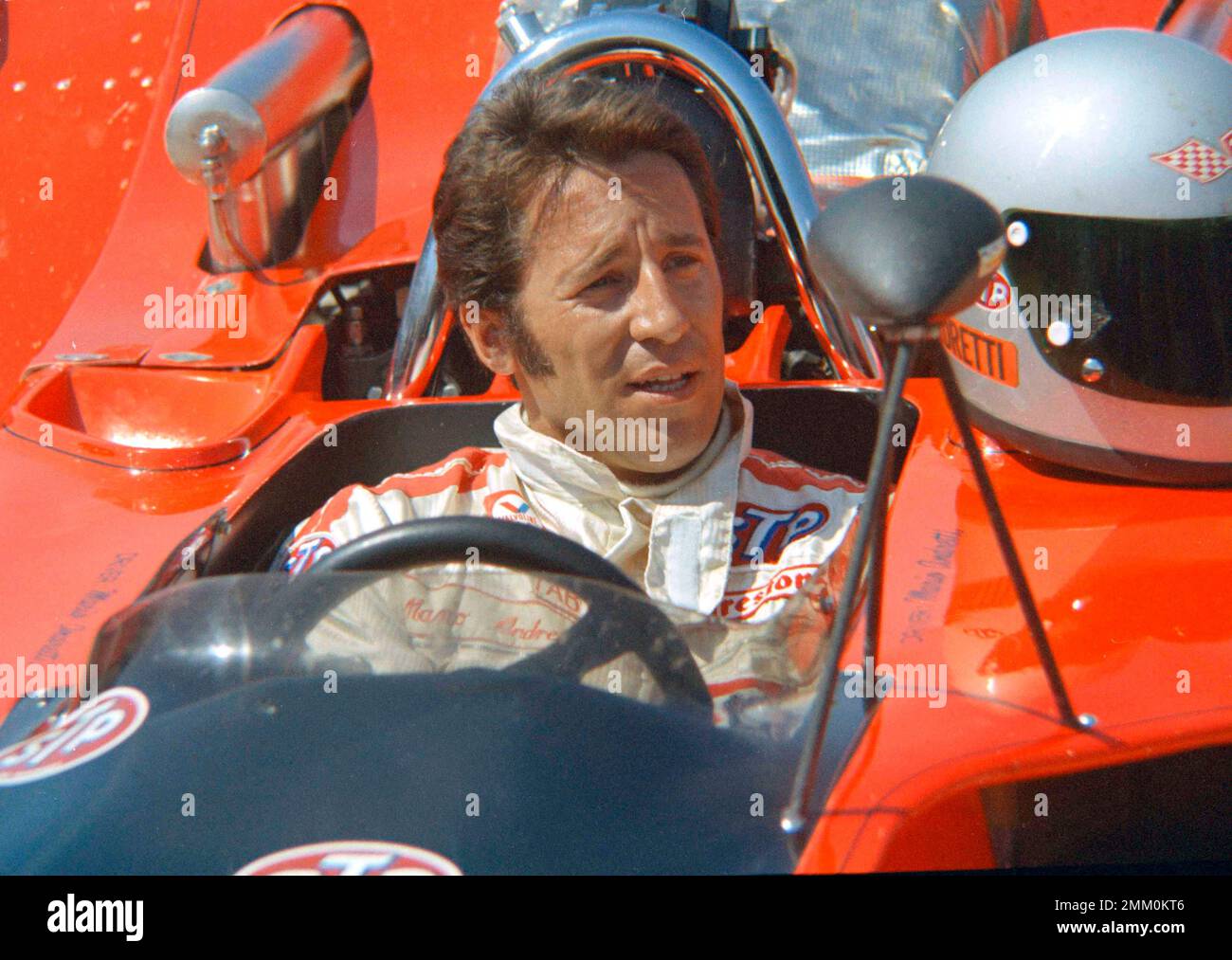 Racer Mario Andretti is pictured in the cockpit of his car at the ...