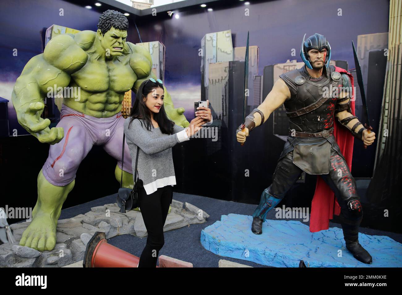 A fans takes selfie in front of comic characters from Marvel Studios at ...