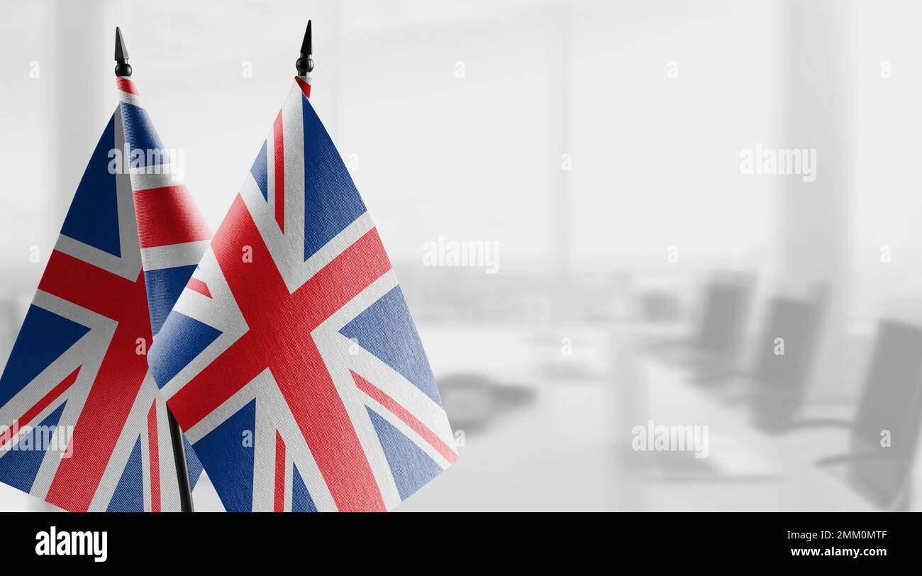 Small flags of the United Kingdom on an abstract blurry background ...