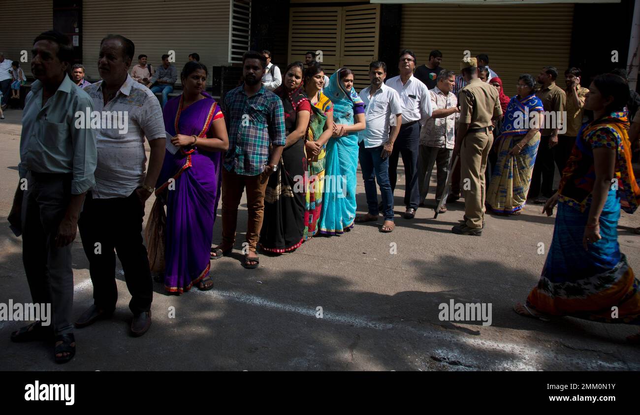 Indian people stand in a queue to cast their votes in Hyderabad, India ...