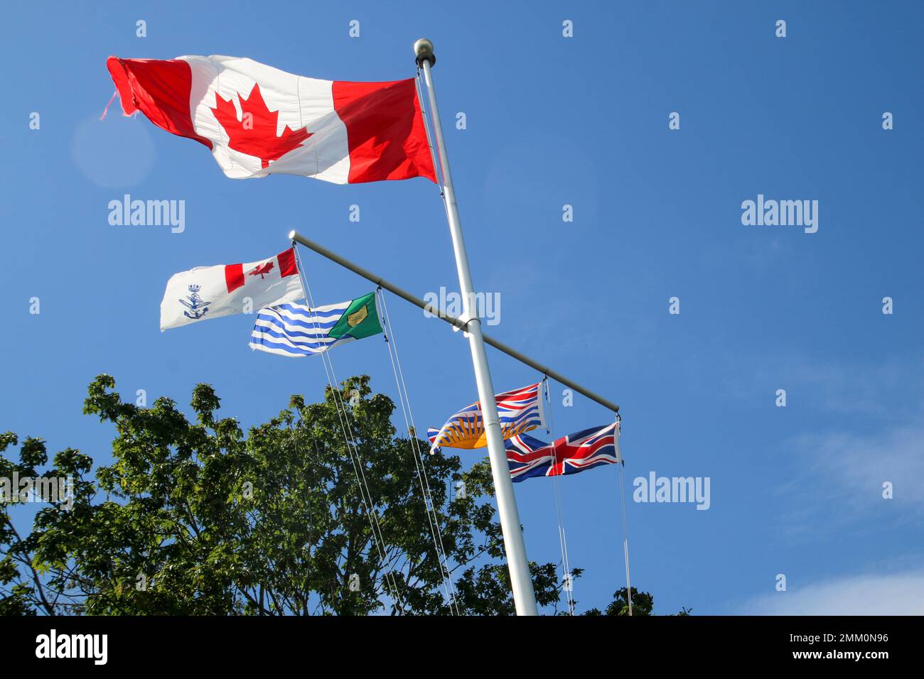 Canadian flag with blue sky background Stock Photo - Alamy