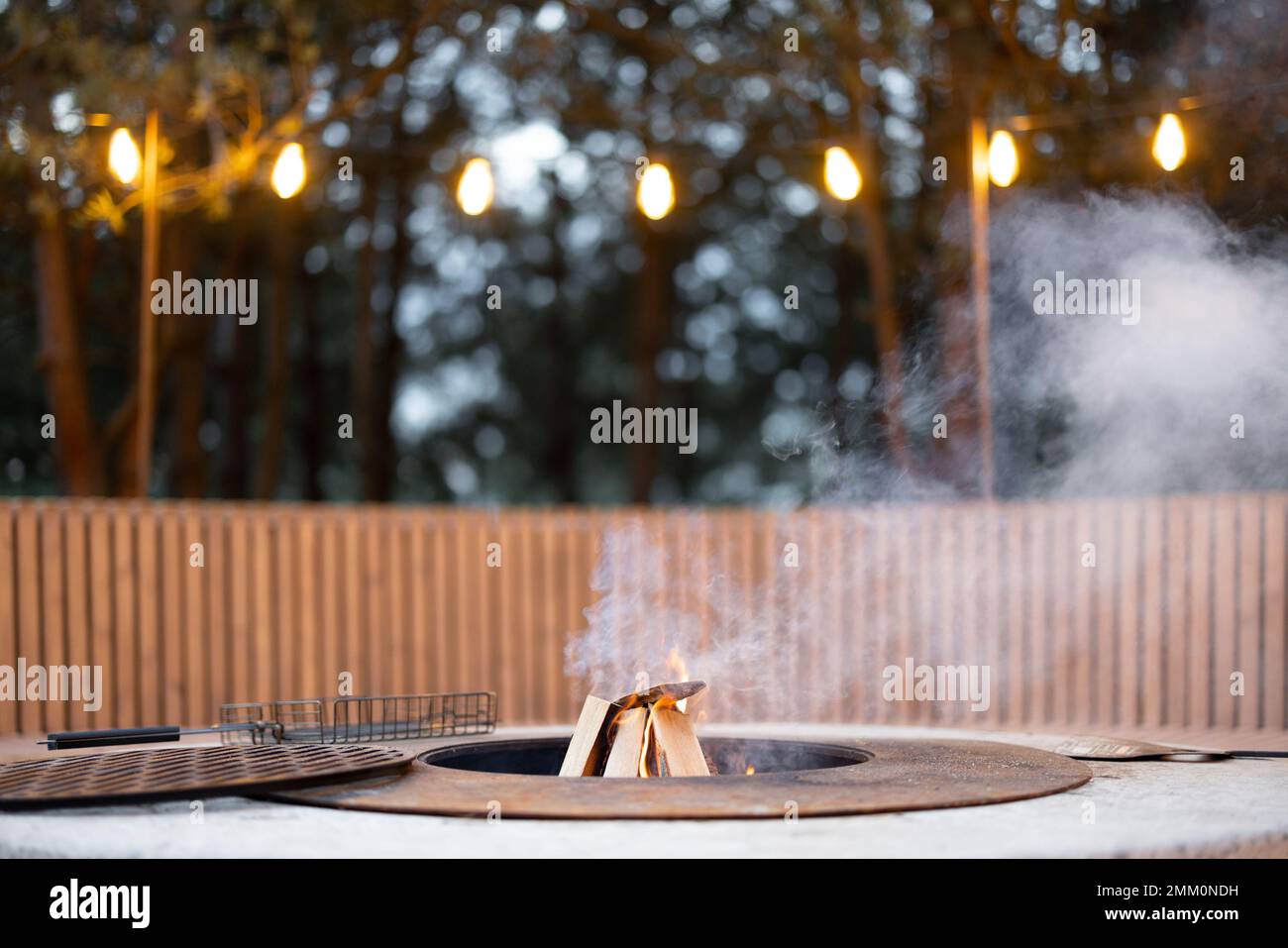 Beautiful lounge area with fireplace and round bench in forest Stock ...
