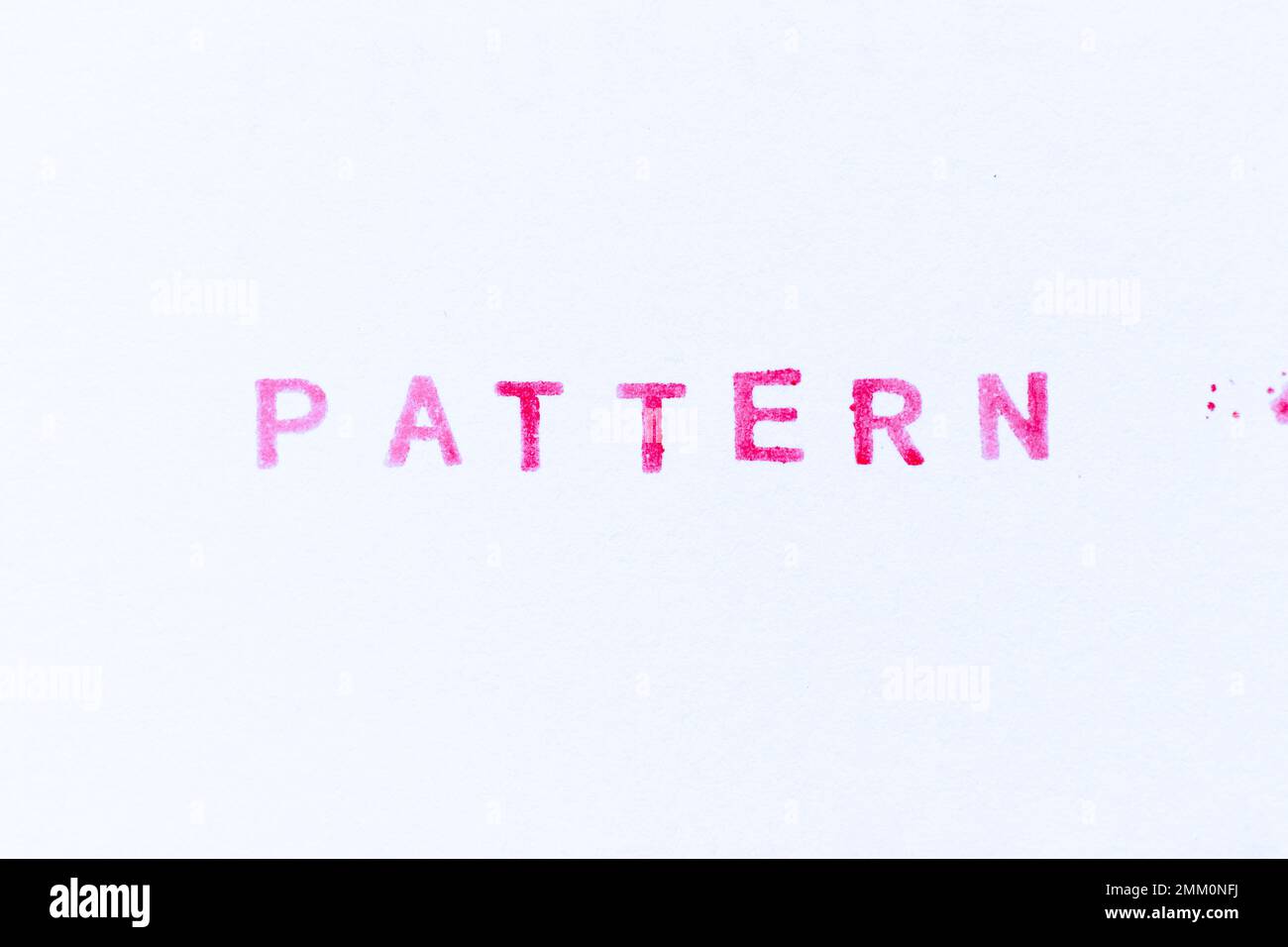 Red color ink rubber stamp in word pattern on white paper background ...