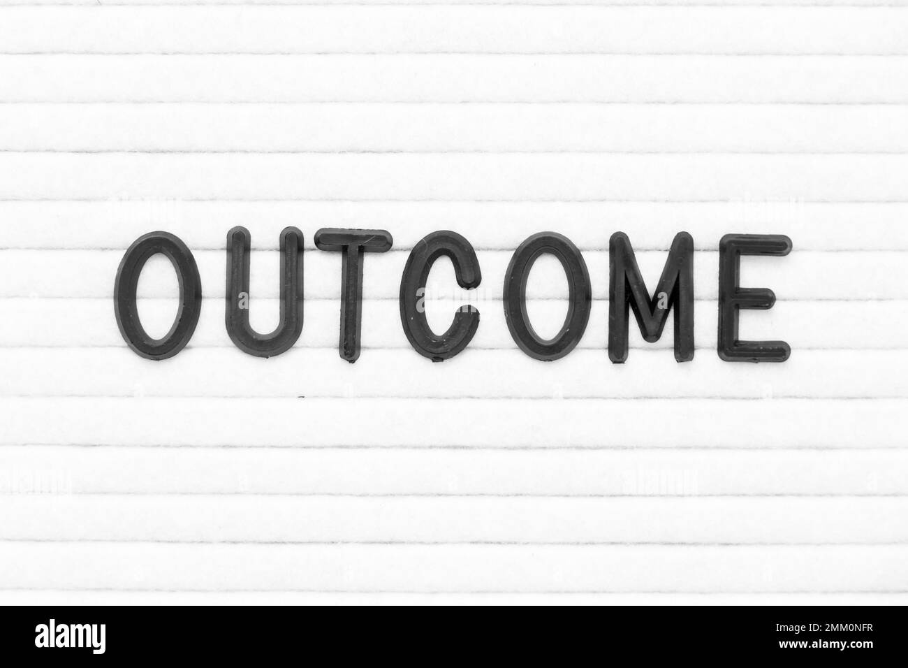Black color letter in word outcome on white felt board background Stock ...