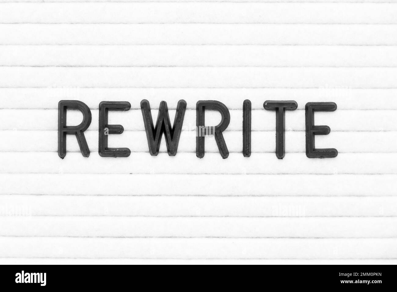 Black color letter in word rewrite on white felt board background Stock ...