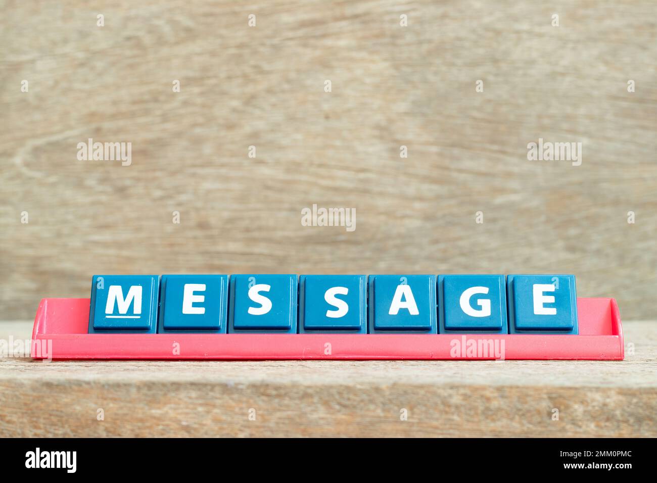 Tile alphabet letter with word message in red color rack on wood ...
