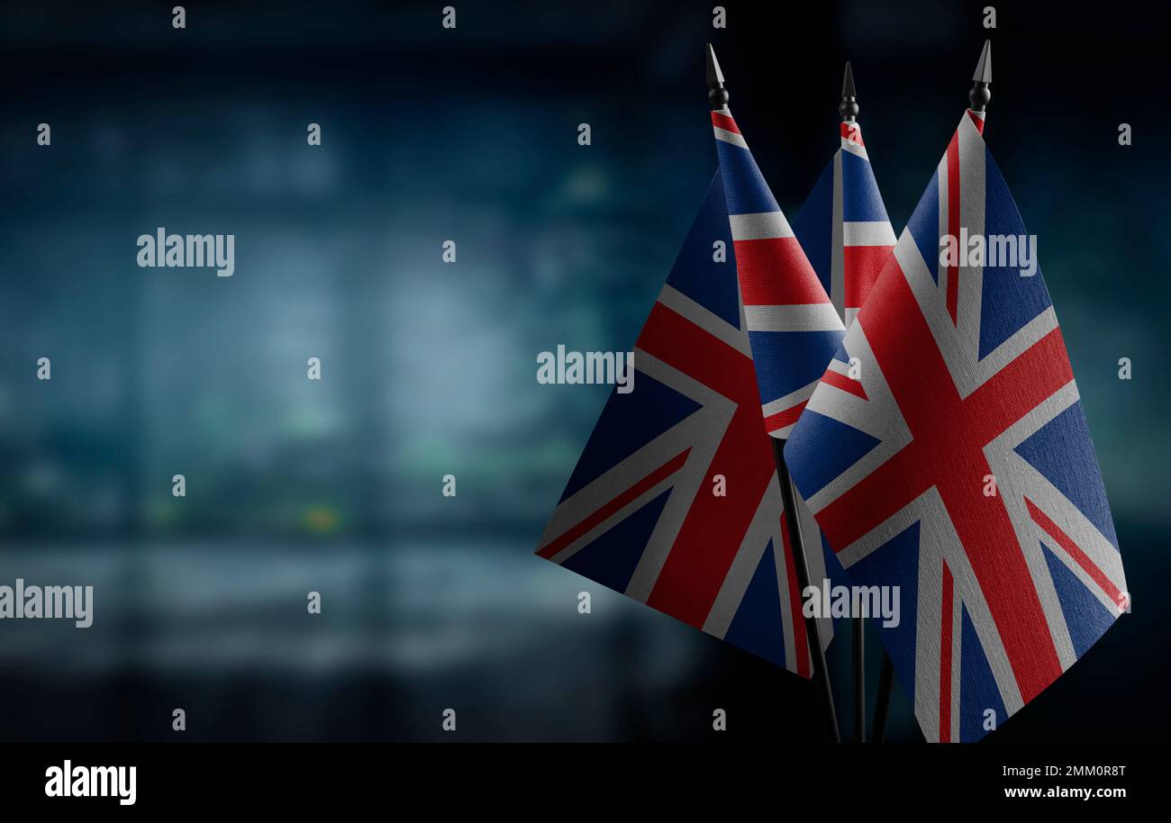 Small flags of the United Kingdom on an abstract blurry background ...