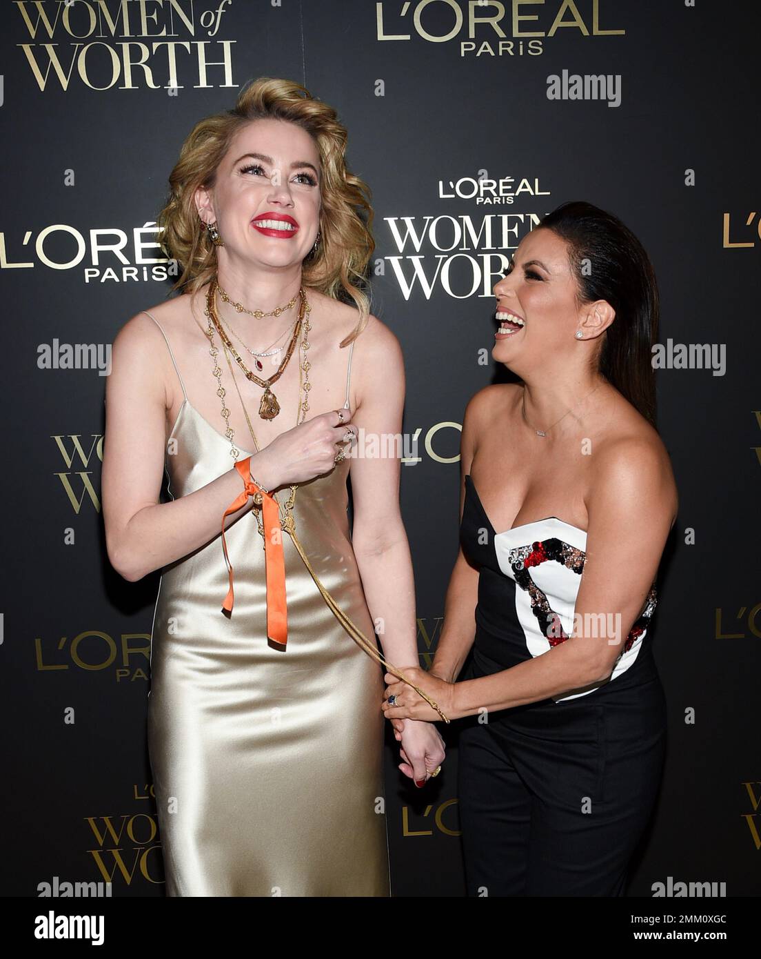 Actresses Amber Heard, left, and Eva Longoria pose together at the 13th ...