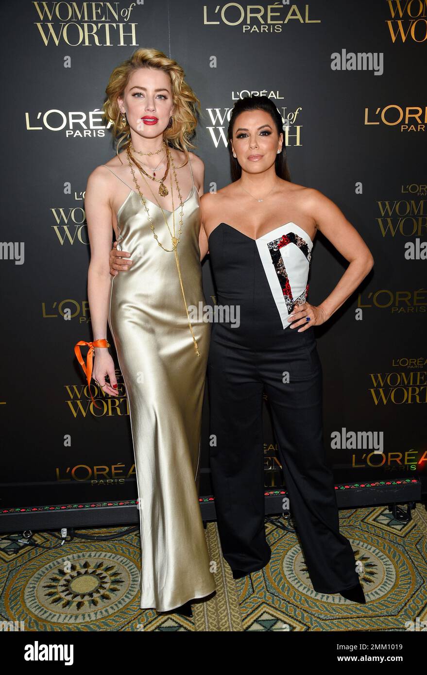 Actresses Amber Heard, left, and Eva Longoria pose together at the 13th ...