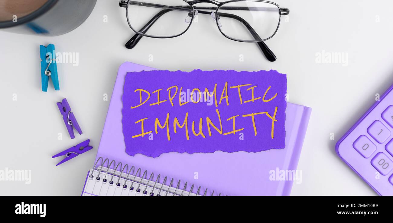 Hand writing sign Diplomatic Immunity. Business approach law that gives ...
