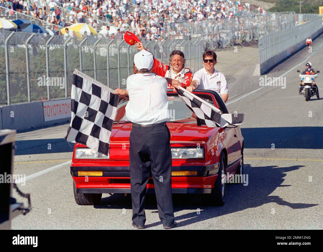 Mario Andretti waves his cap during a final ceremonial lap as Andretti ...