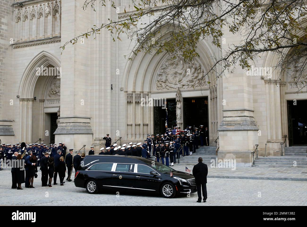 Family members of former President George H.W. Bush follow his flag ...