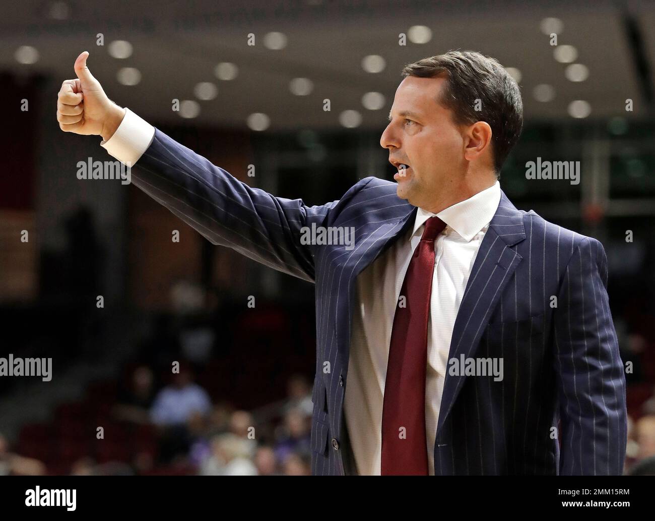 Elon head coach Matt Matheny directs his team against Furman in the ...