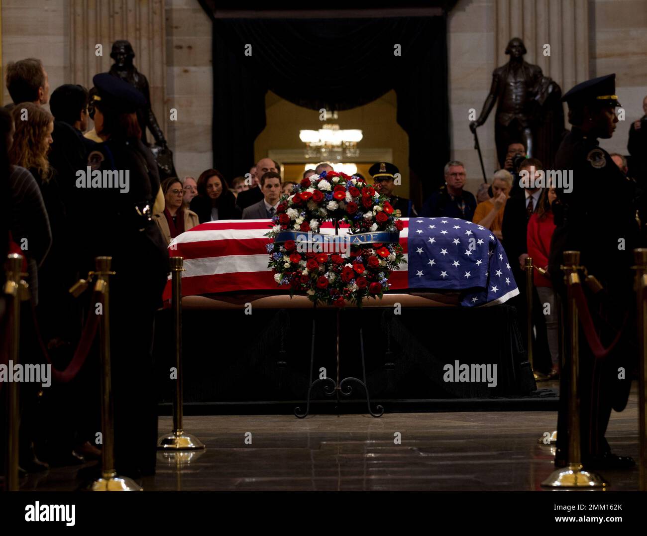 The flag-draped casket of former President George H.W. Bush lies in ...