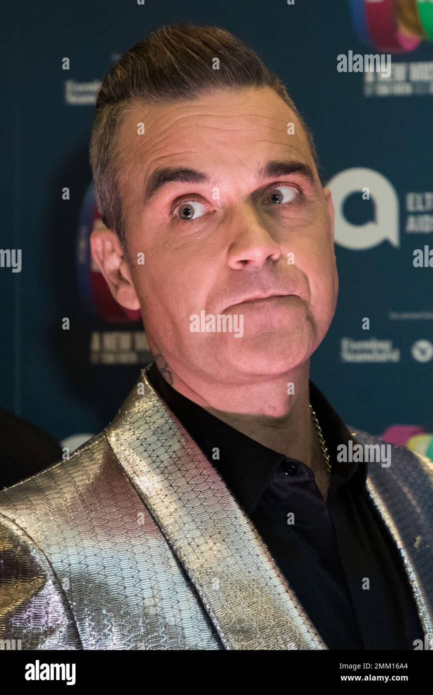 Singer Robbie Williams poses for photographers upon arrival at the ...