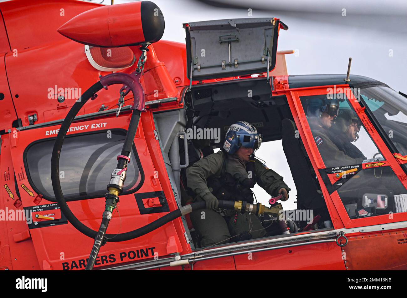Petty Officer 2nd Class Joanne Cobar connects a pump while conducting ...