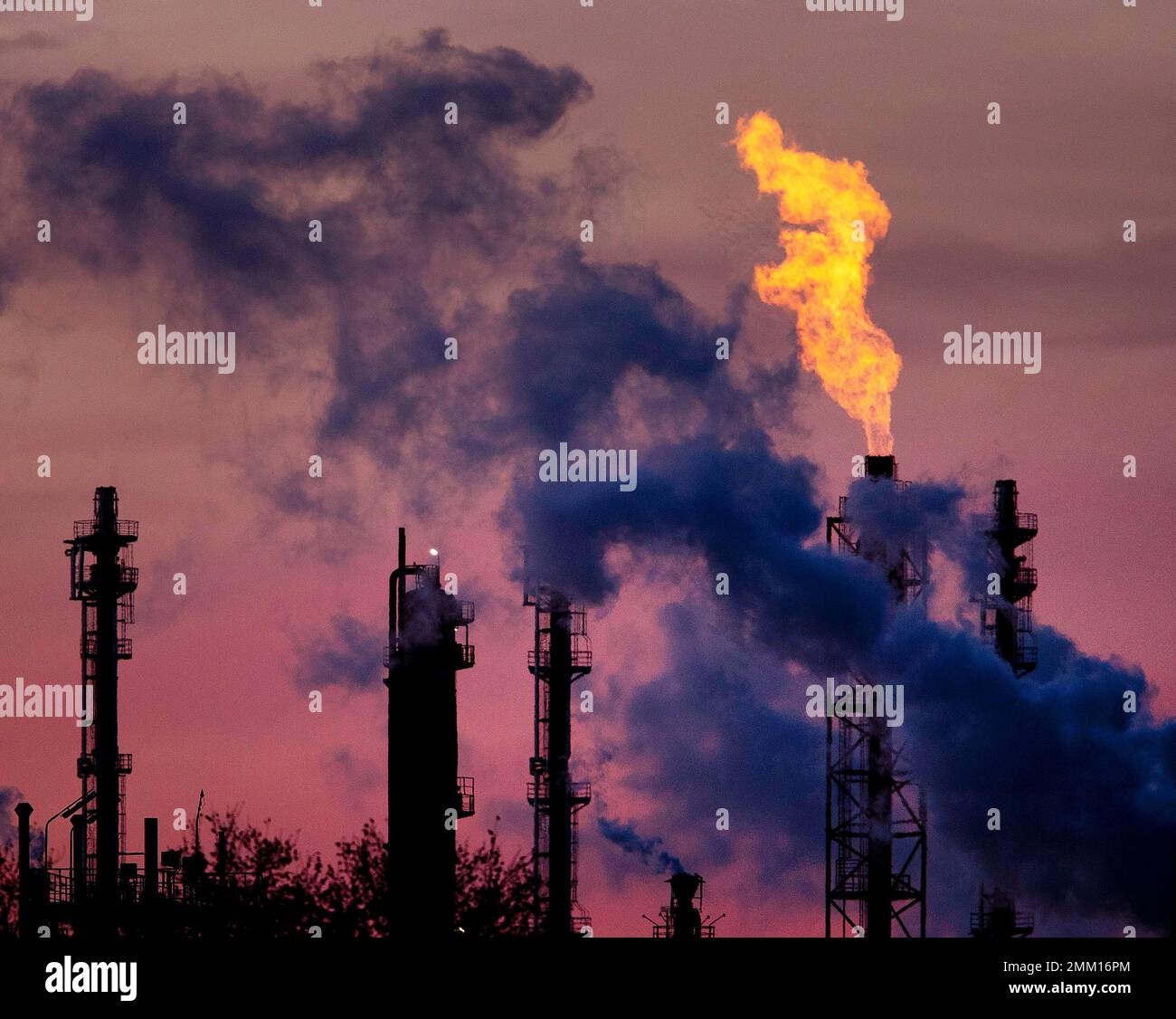 A flame emits from a chimney at the BASF chemical company in ...