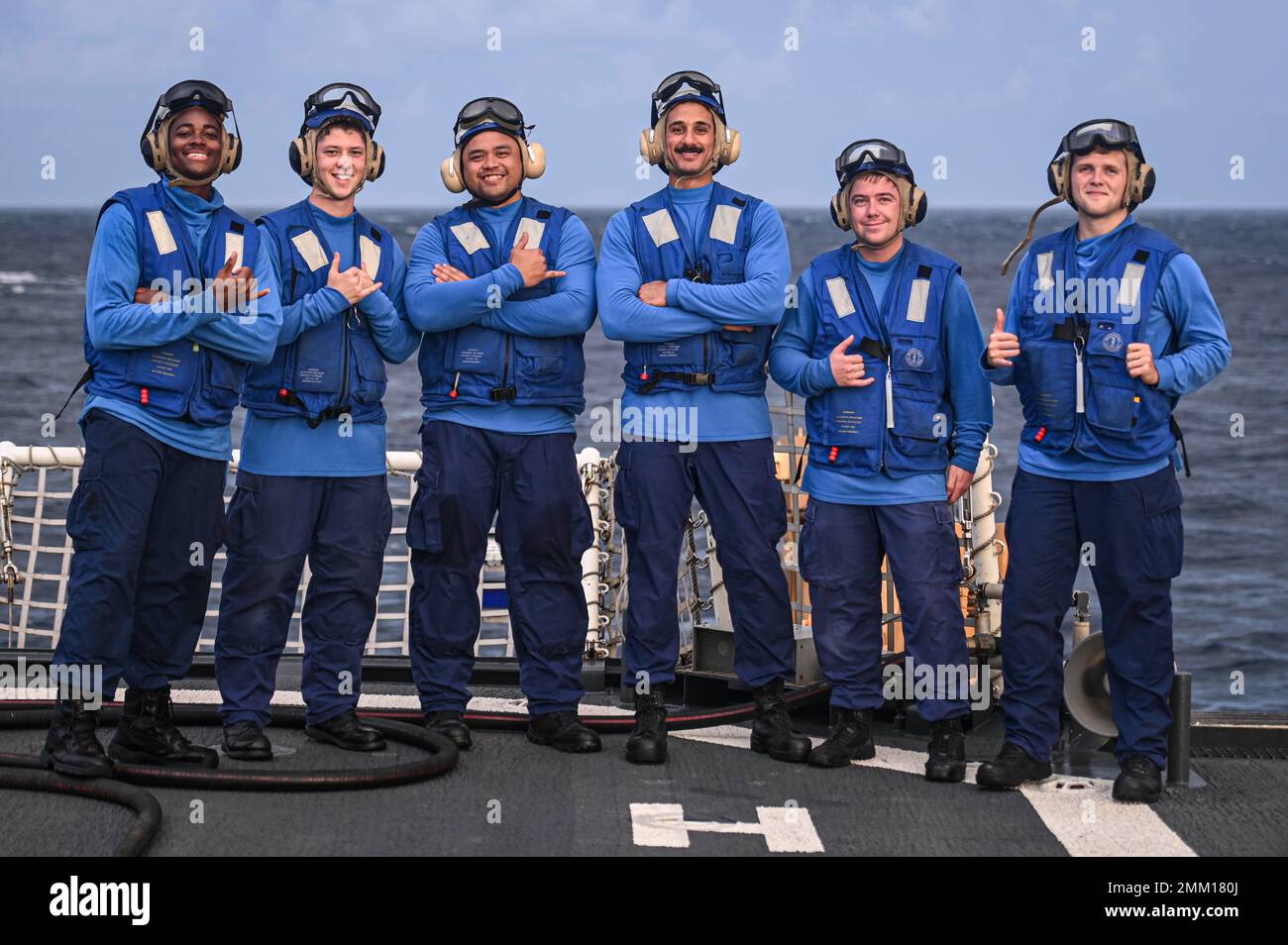 Members from U.S. Coast Guard Cutter Midgett (WMSL 757) pose for a ...